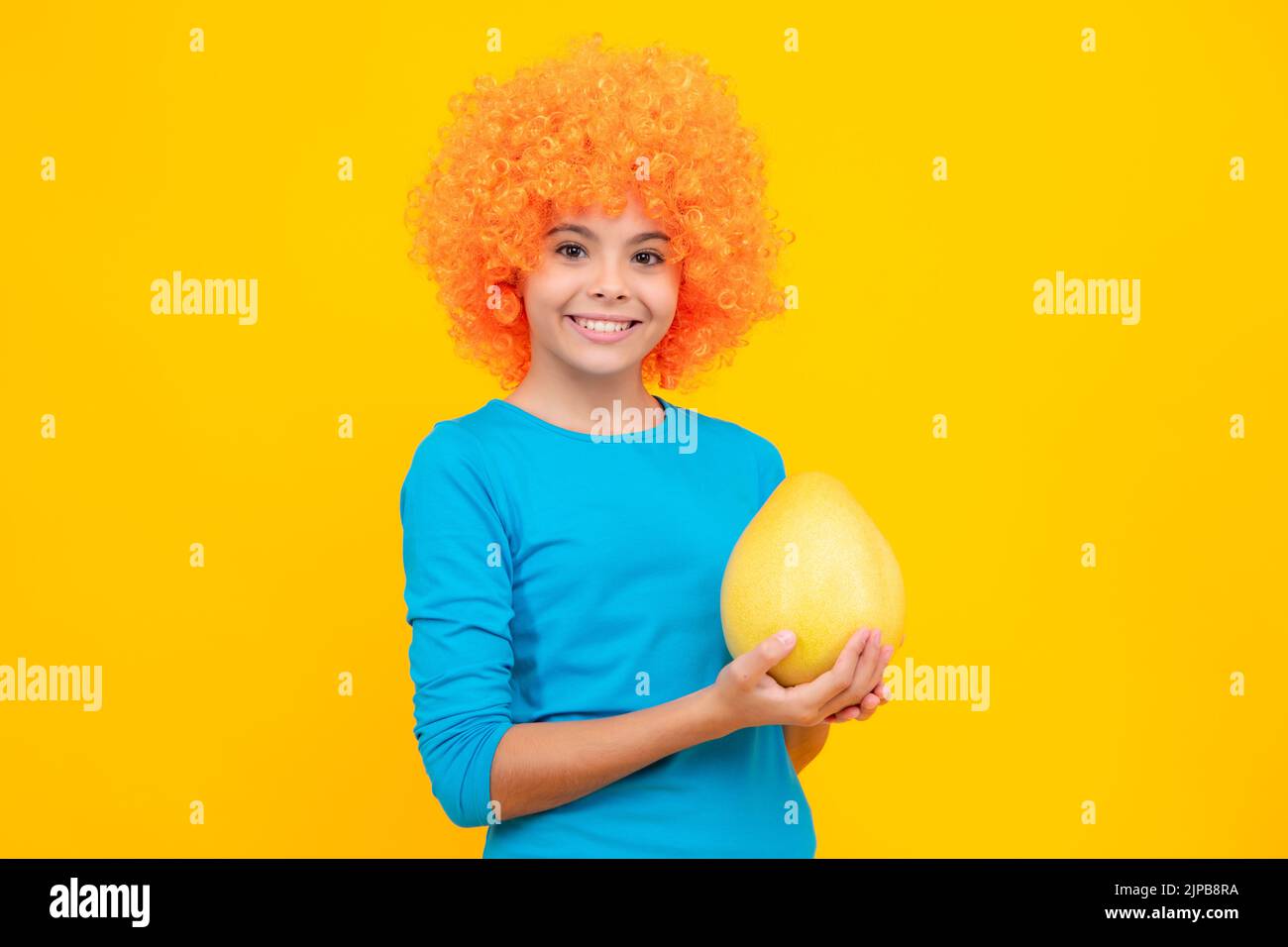 Teenager child girl hold citrus fruit pummelo or pomelo full of vitamin ...