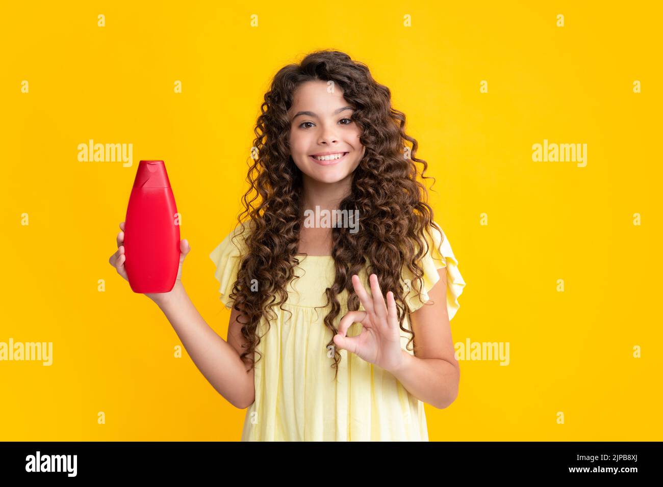 Teenage girl with shampoos conditioners or shower gel. Kids hair care ...