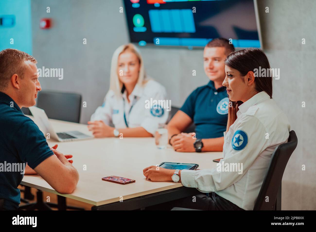 Group of security guards sitting and having briefing In the system ...