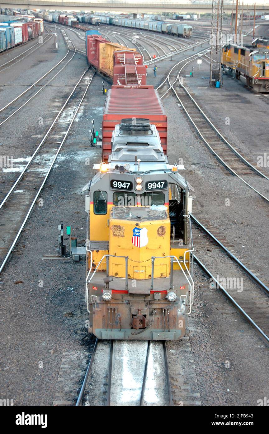Railroad train yard with sidings and switchers and engines and cars and ...
