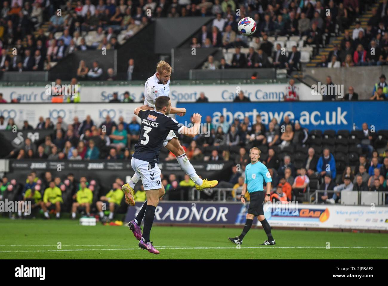 Harry Darling #6 of Swansea City headers at goal Under pressure from ...