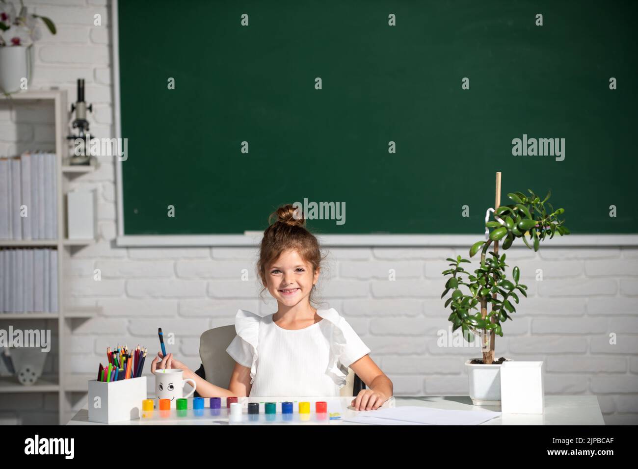 Child girl drawing with coloring pens paintind. Portrait of adorable ...