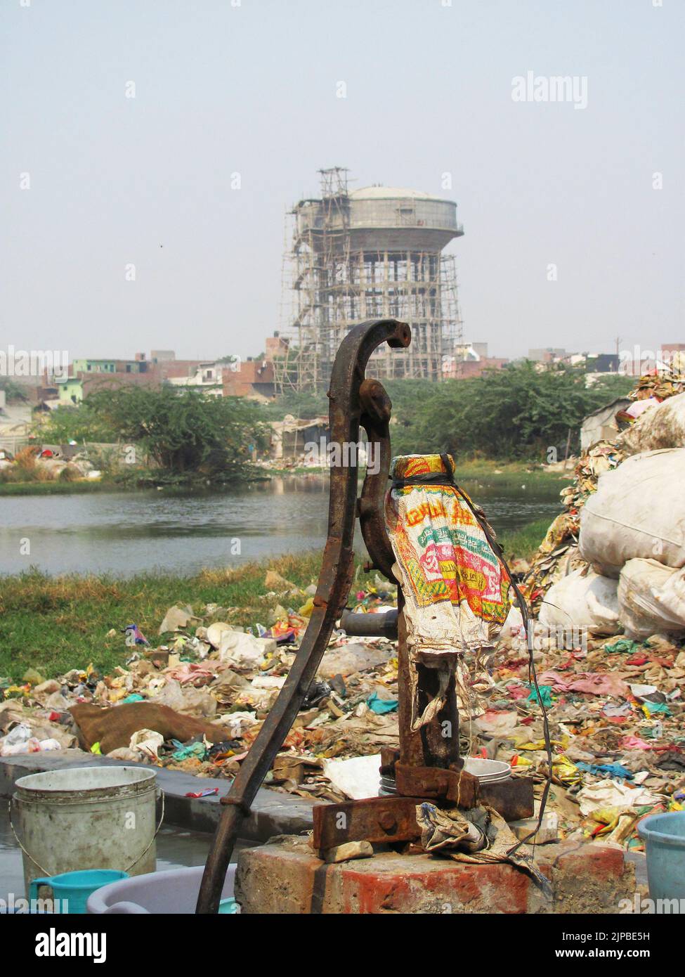 Communal water well next to a refuse dump Stock Photo - Alamy