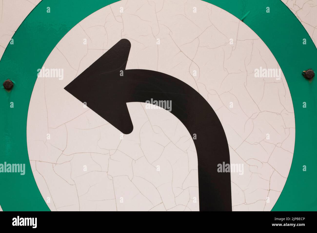 Black turn left directional arrow on a white and green traffic sign ...