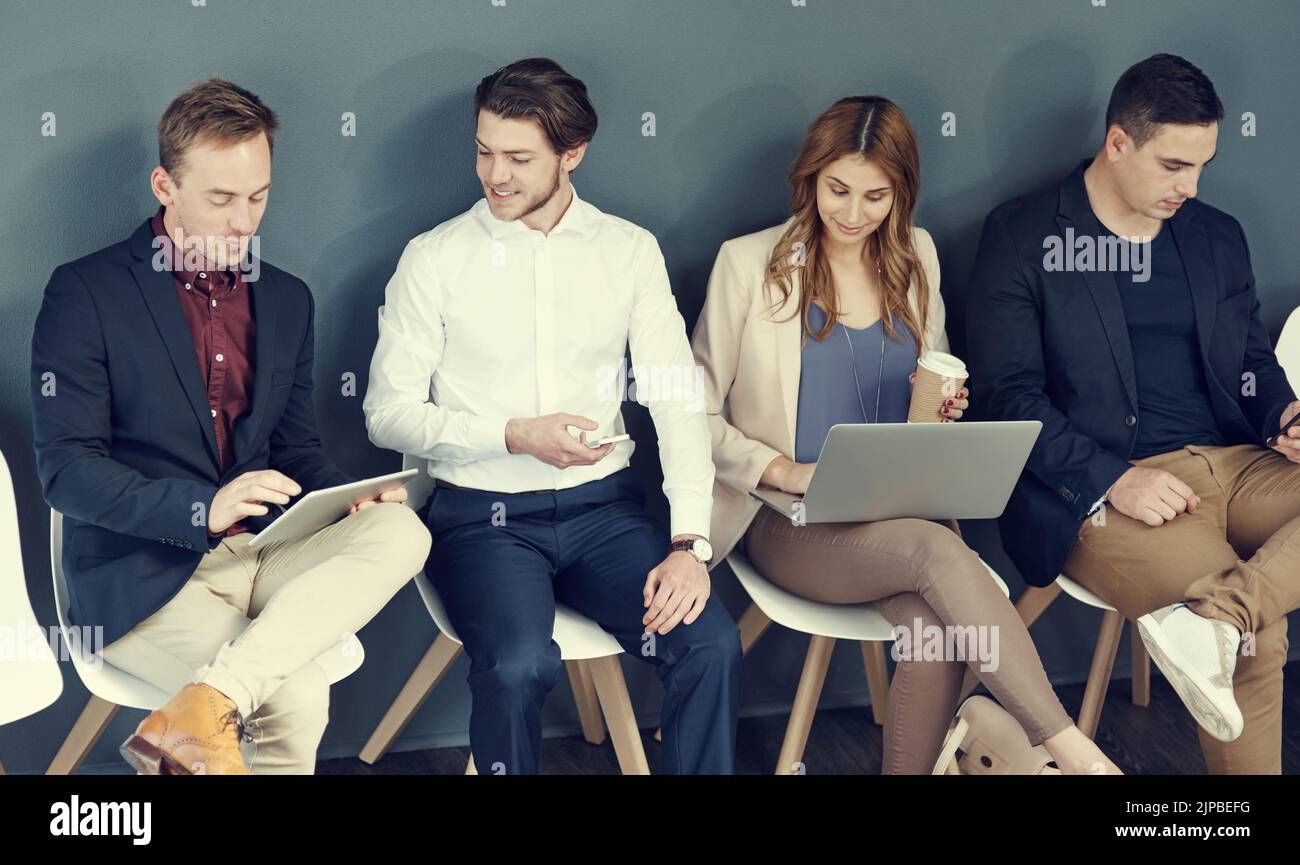 Connecting with the candidates. a group of businesspeople using ...