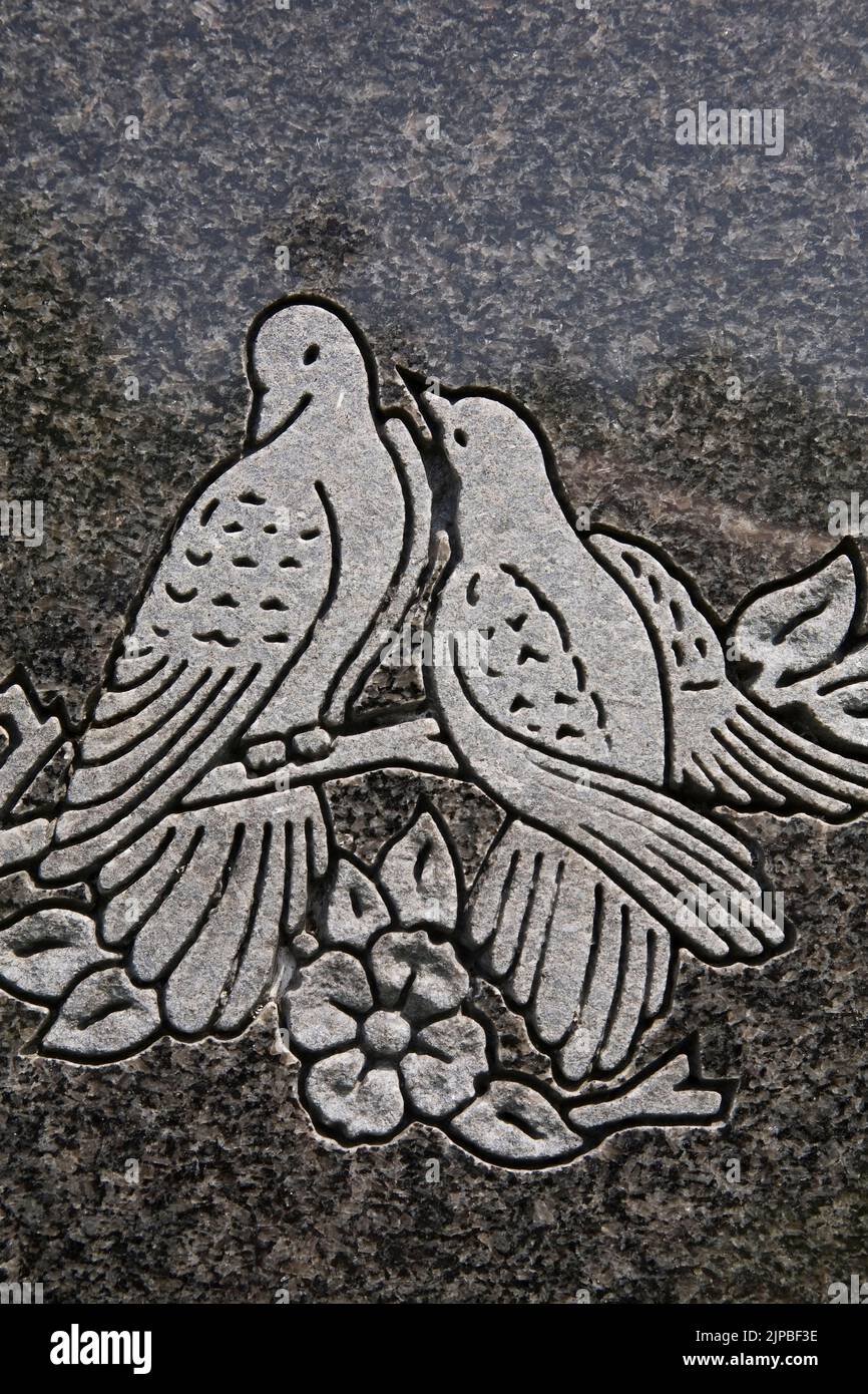 Mourning doves depicted on memorial monument in cemetery Stock Photo ...