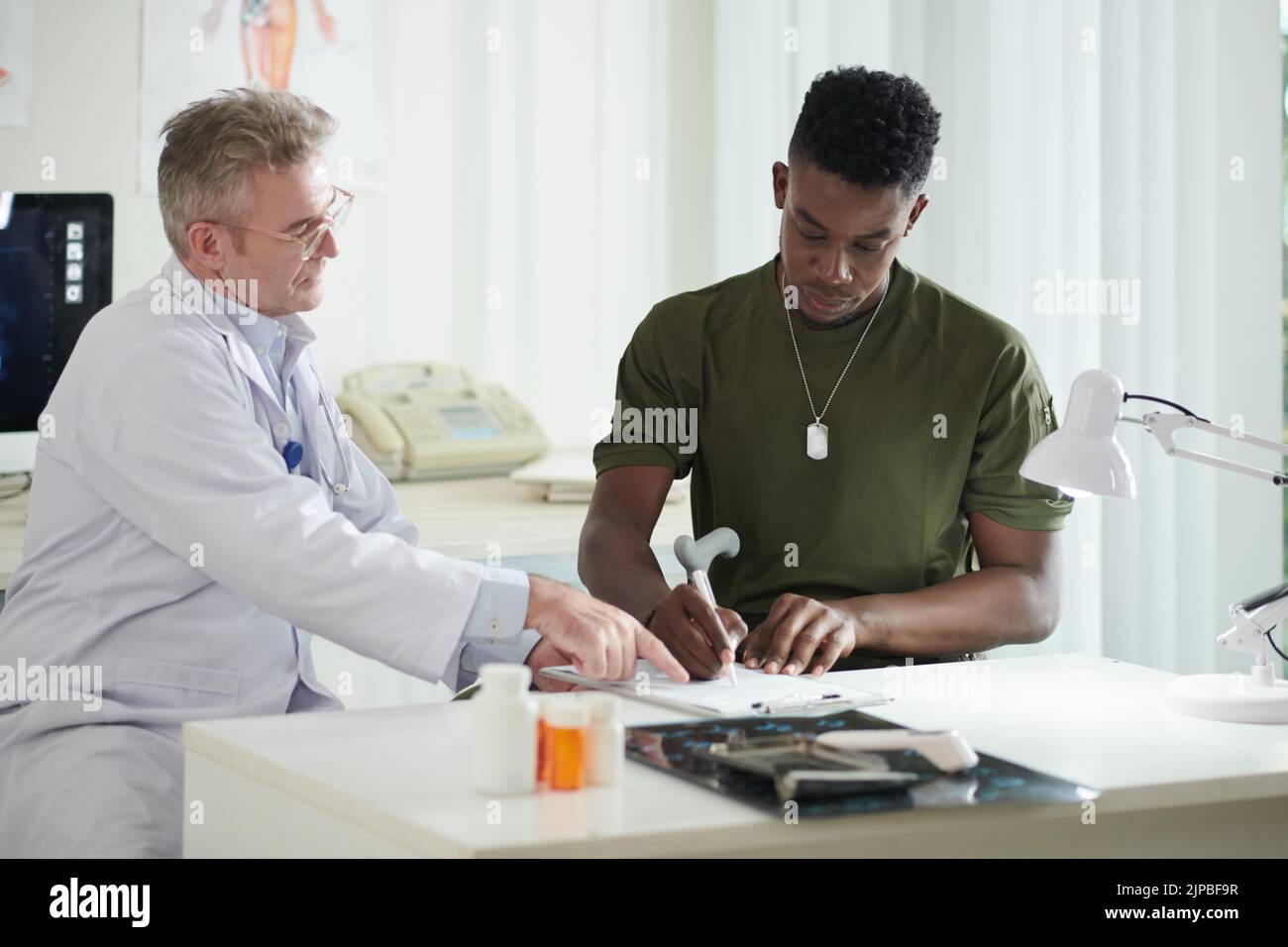 Ex-soldier filling out mediccal documents before getting annual check ...