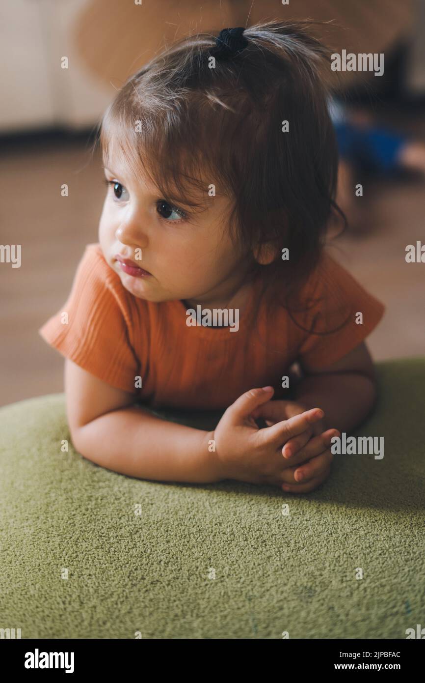 Baby girl pretty face with beautiful deep eyes looking away while ...