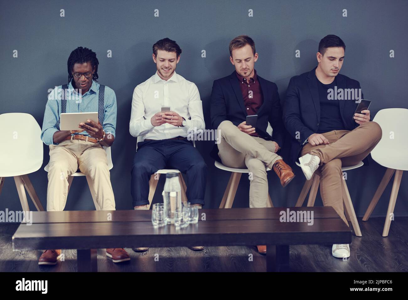 Which man will get the job. a group of businessmen using different ...