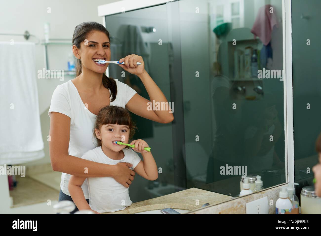 Big girls brush their teeth twice a day. Portrait of a mother and ...