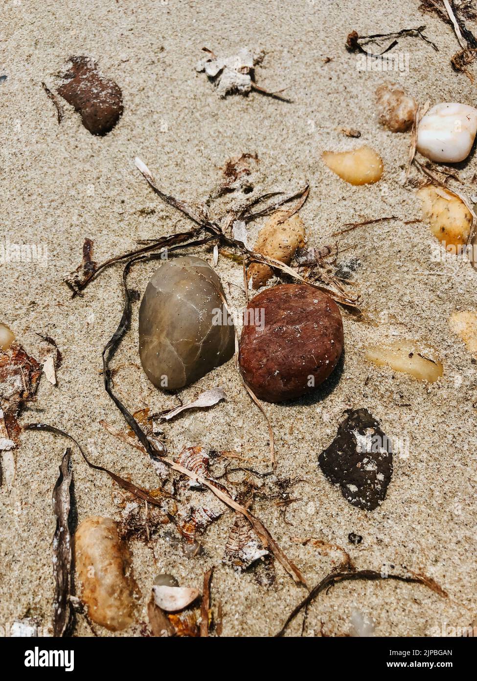 Sea stones on sandy wet beach. Summer background texture wallpaper. Top ...