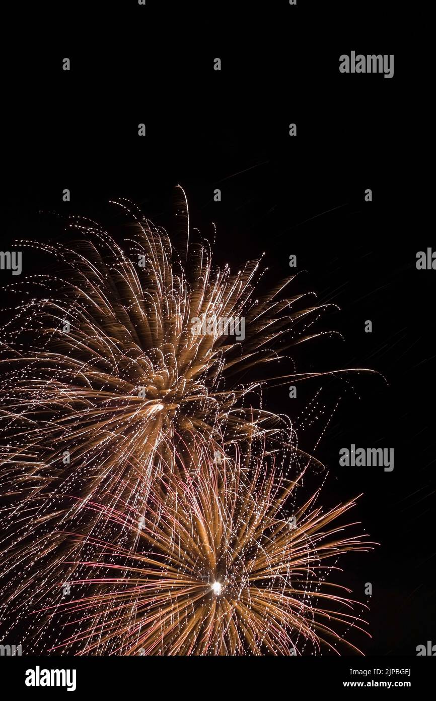 Red, golden and orange fireworks in the night sky Stock Photo - Alamy