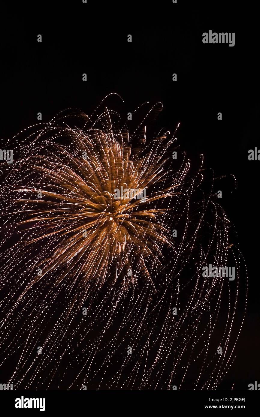 Red and golden fireworks in the night sky Stock Photo - Alamy