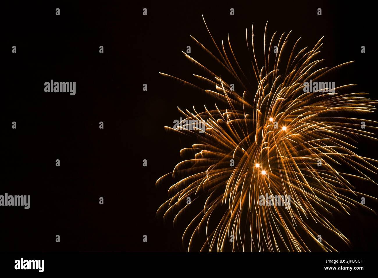 Gold and yellow fireworks in the night sky Stock Photo - Alamy