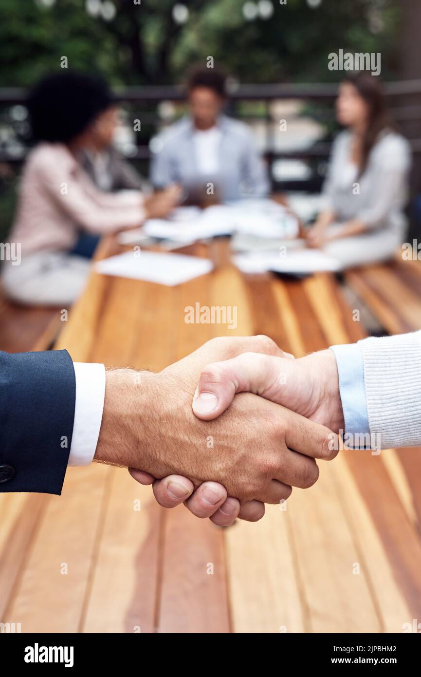 Lets shake on it. two unrecognizable businessmen shaking hands while ...