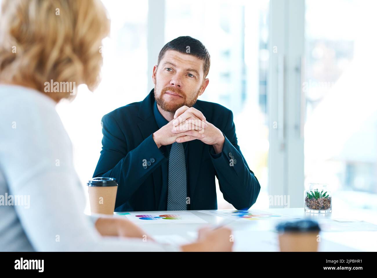 Shes got his full attention. two businesspeople having a meeting in an ...