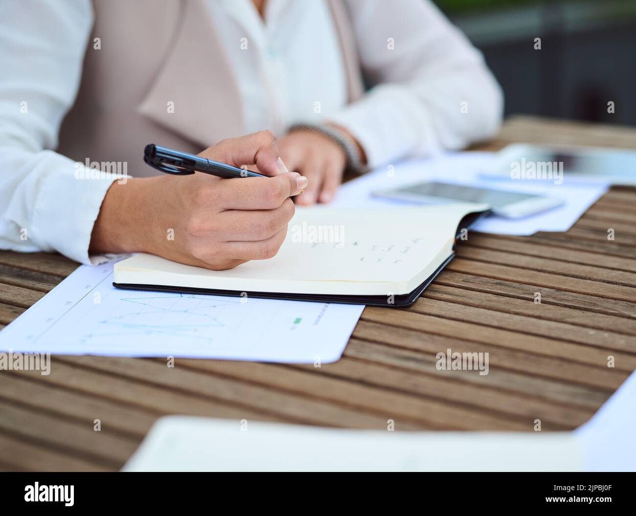 Taking extensive notes. an unrecognizable young businesswoman taking ...
