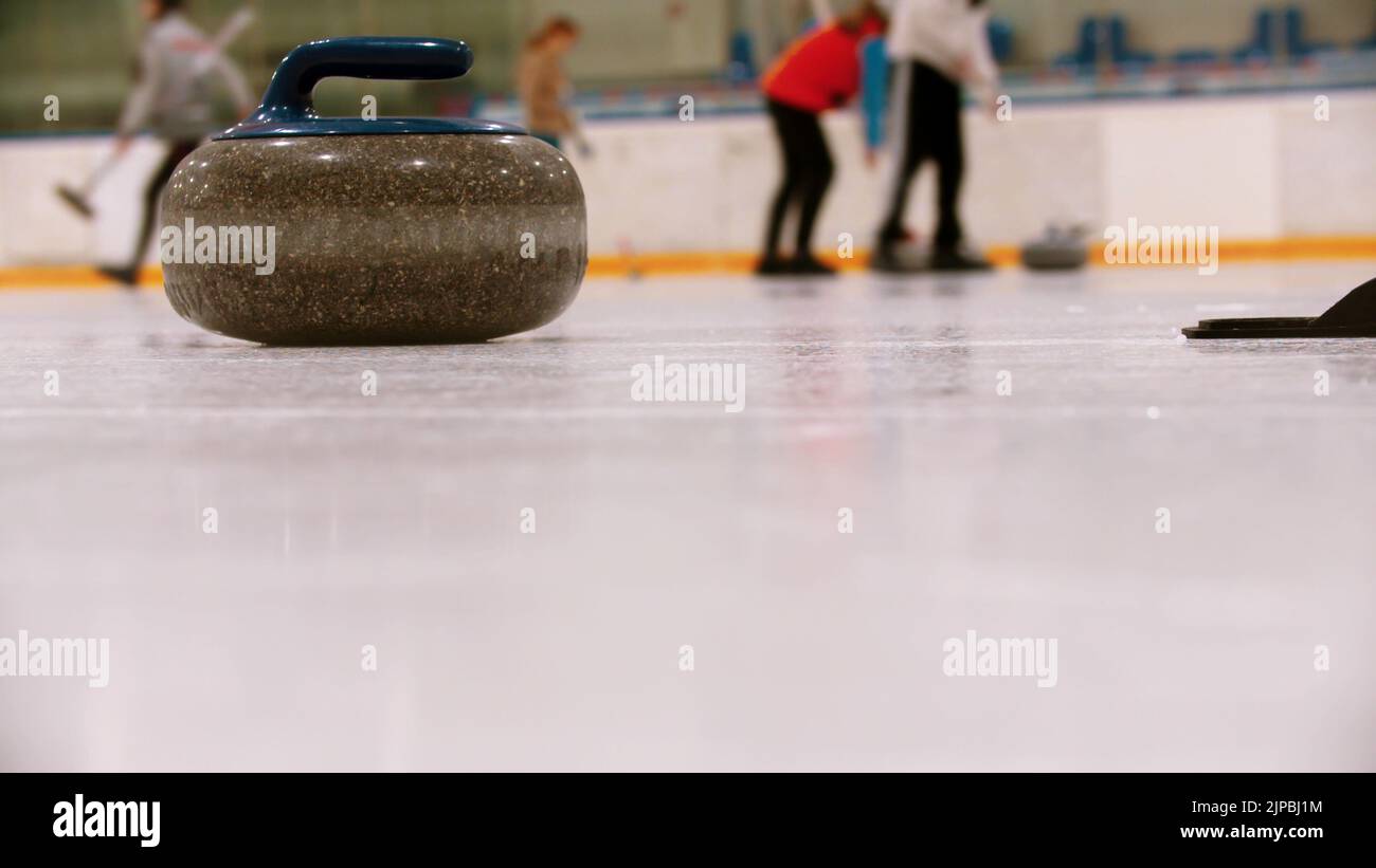 Curling - a granite stone on the ice field Stock Photo - Alamy