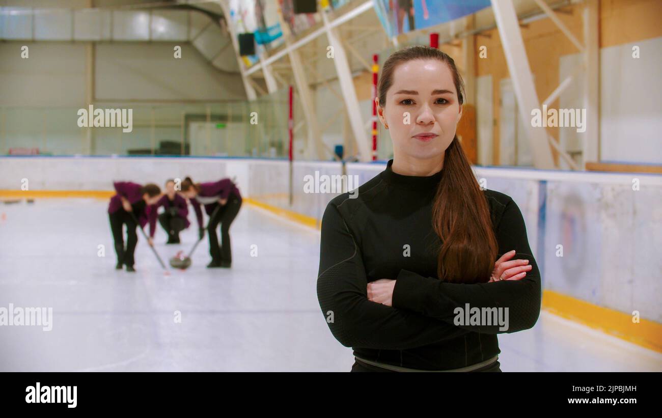 Curling training - the judge standing on the ice rink looking in the ...