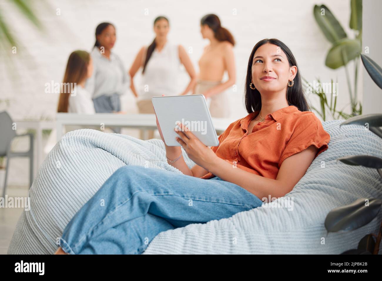 Thinking, idea and wondering female employee sitting and browsing on a ...