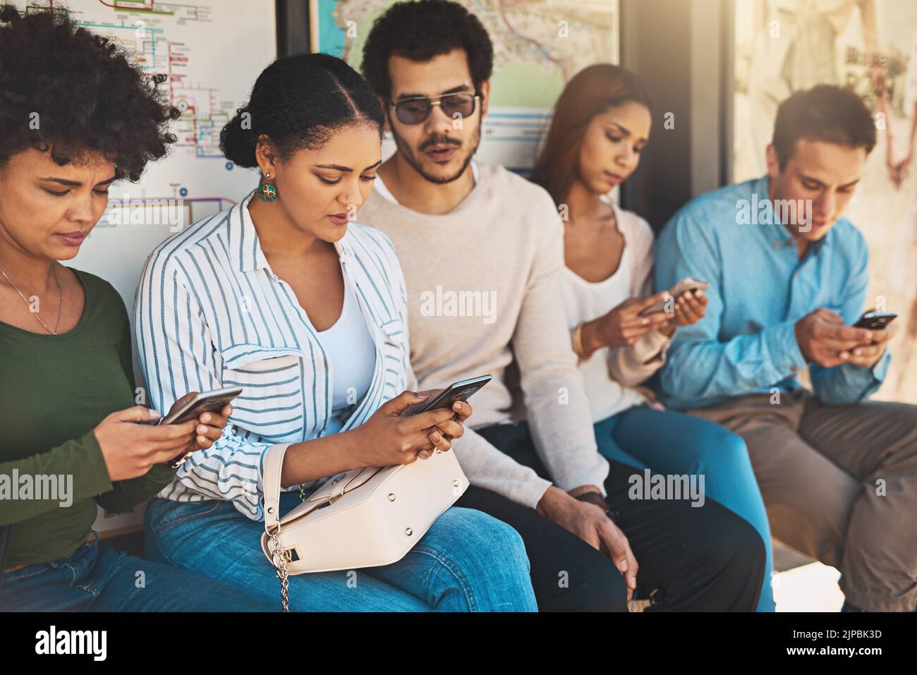 We are being very social on our phones today. a group of focused young ...