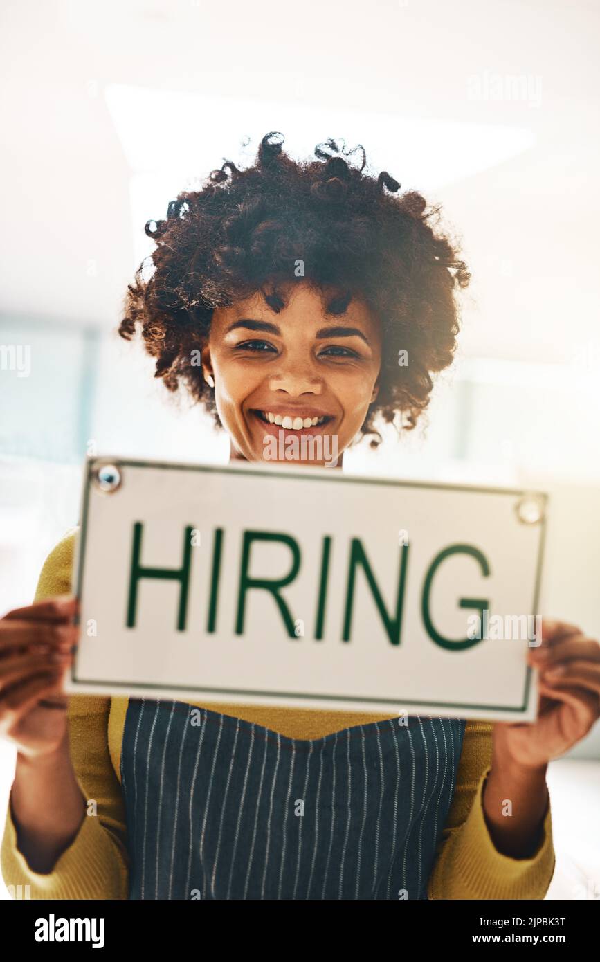 Theres a new job with your name on it. a young woman holding up a ...