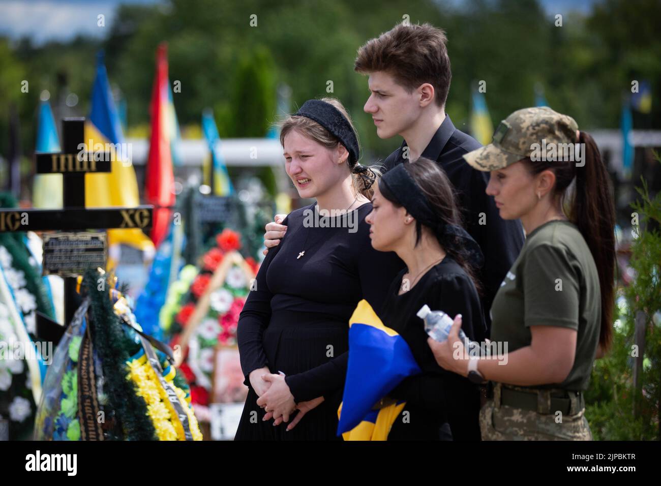 Relatives react emotionally during the funeral ceremony of a Ukrainian ...