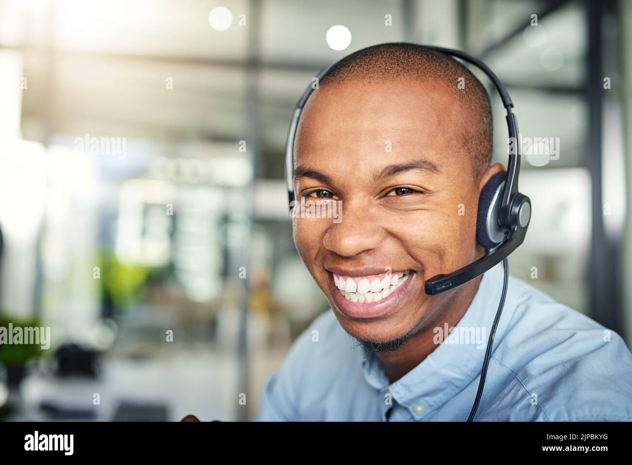 Supporting the customer with one smile at a time. a young handsome male ...