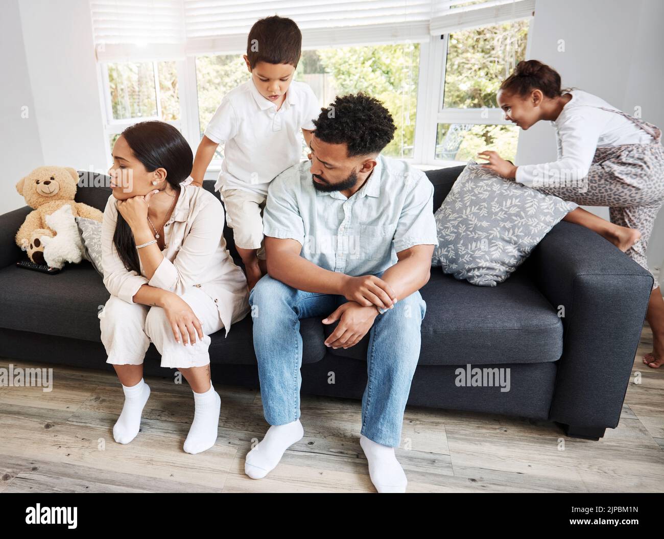 Frustrated, annoyed and irritated couple sitting on the couch with ...