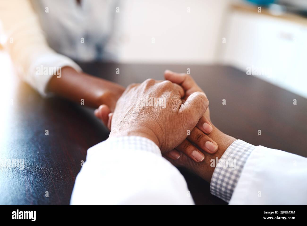 Youre in my hands now. Closeup shot of an unrecognizable doctor holding ...