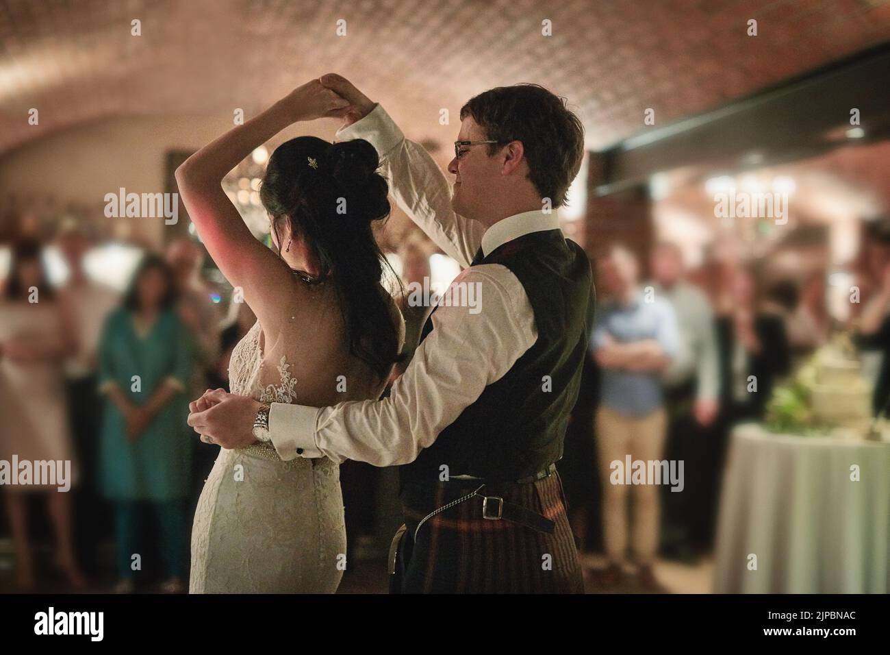 The first dance goes to you two. a cheerful bride and groom having the ...