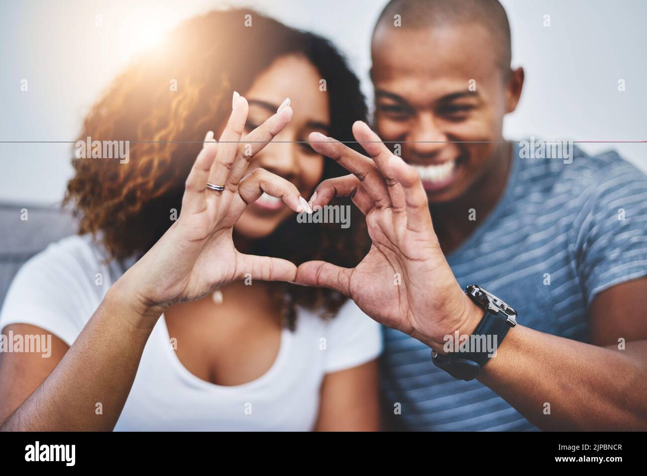 Theres so much we love about each other. a young couple making a heart ...