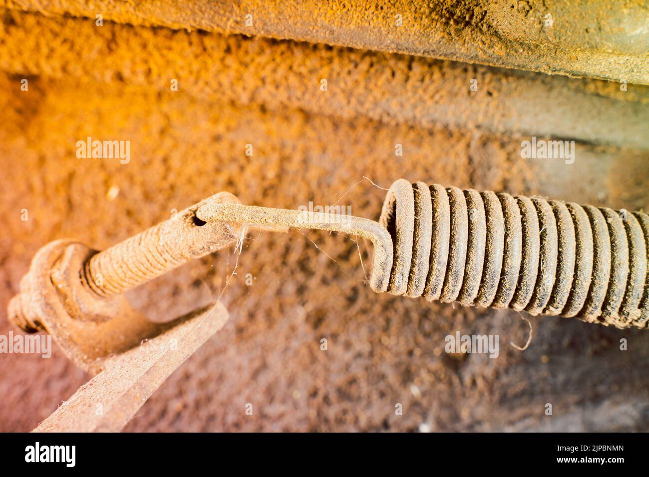A close-up of the spring in the control mechanism of the walk-behind ...