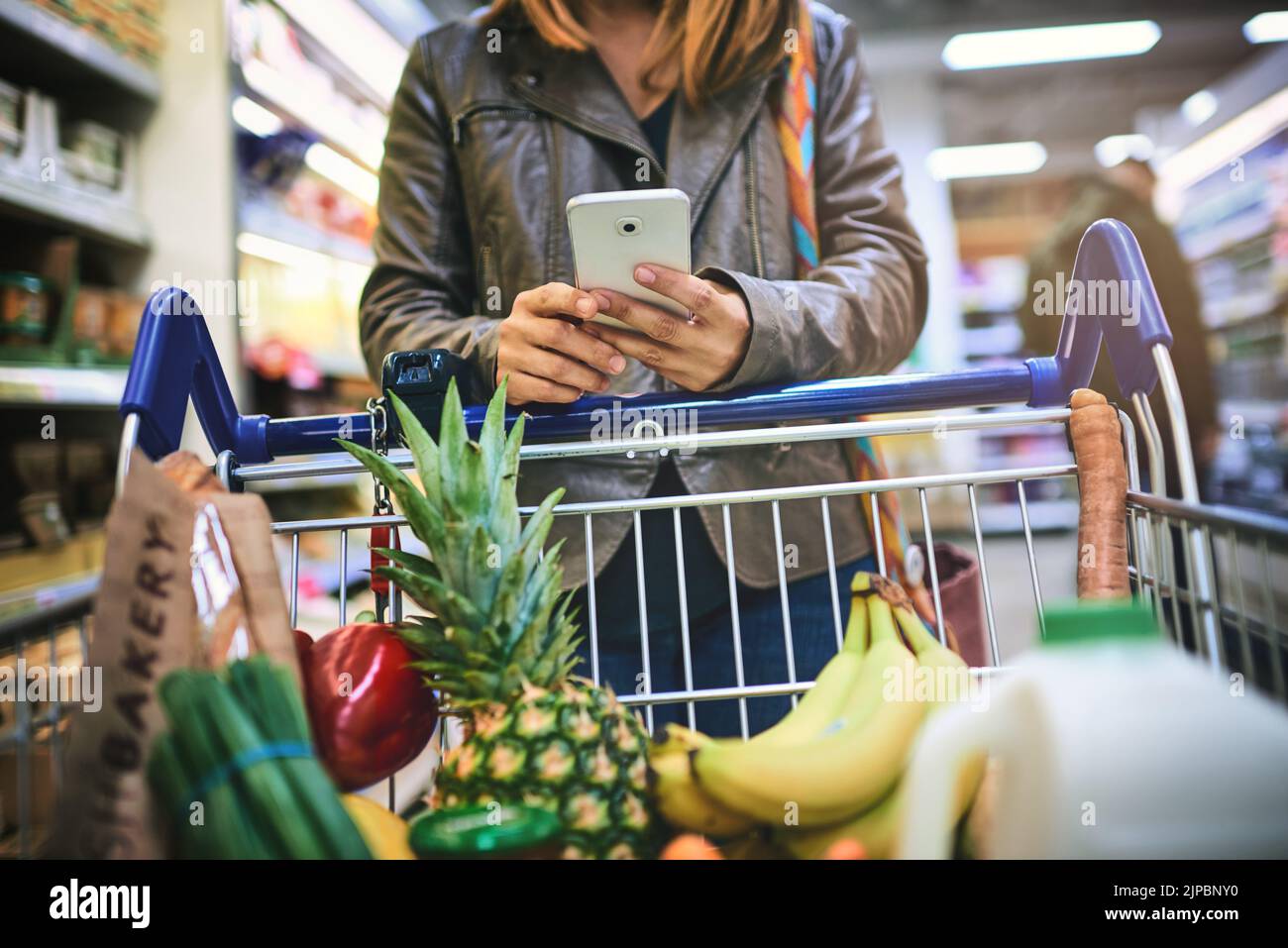 Woman texting in store hi-res stock photography and images - Alamy
