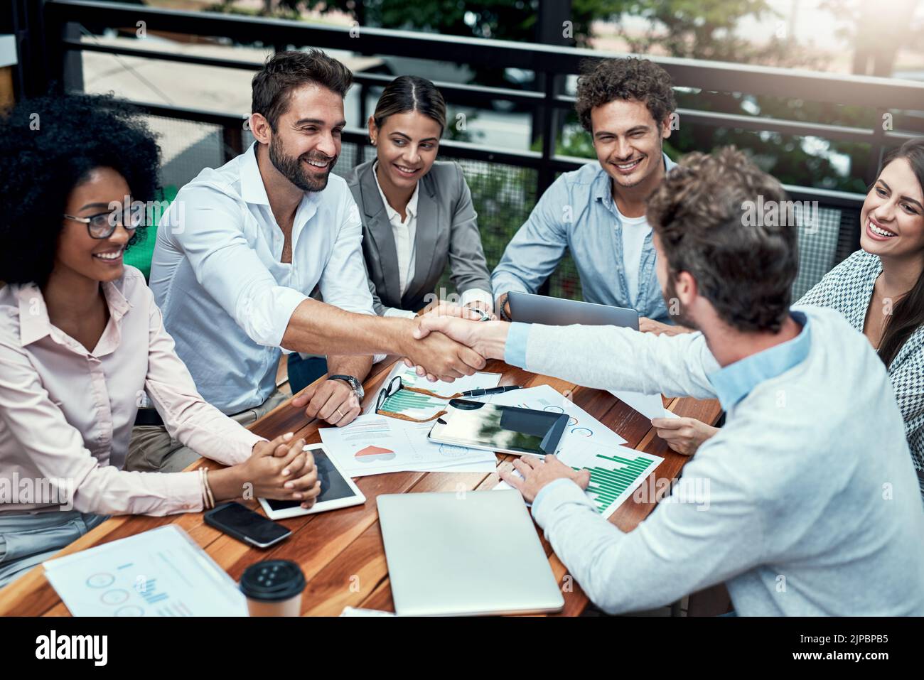 Welcoming new talent to the team. businesspeople shaking hands during a ...