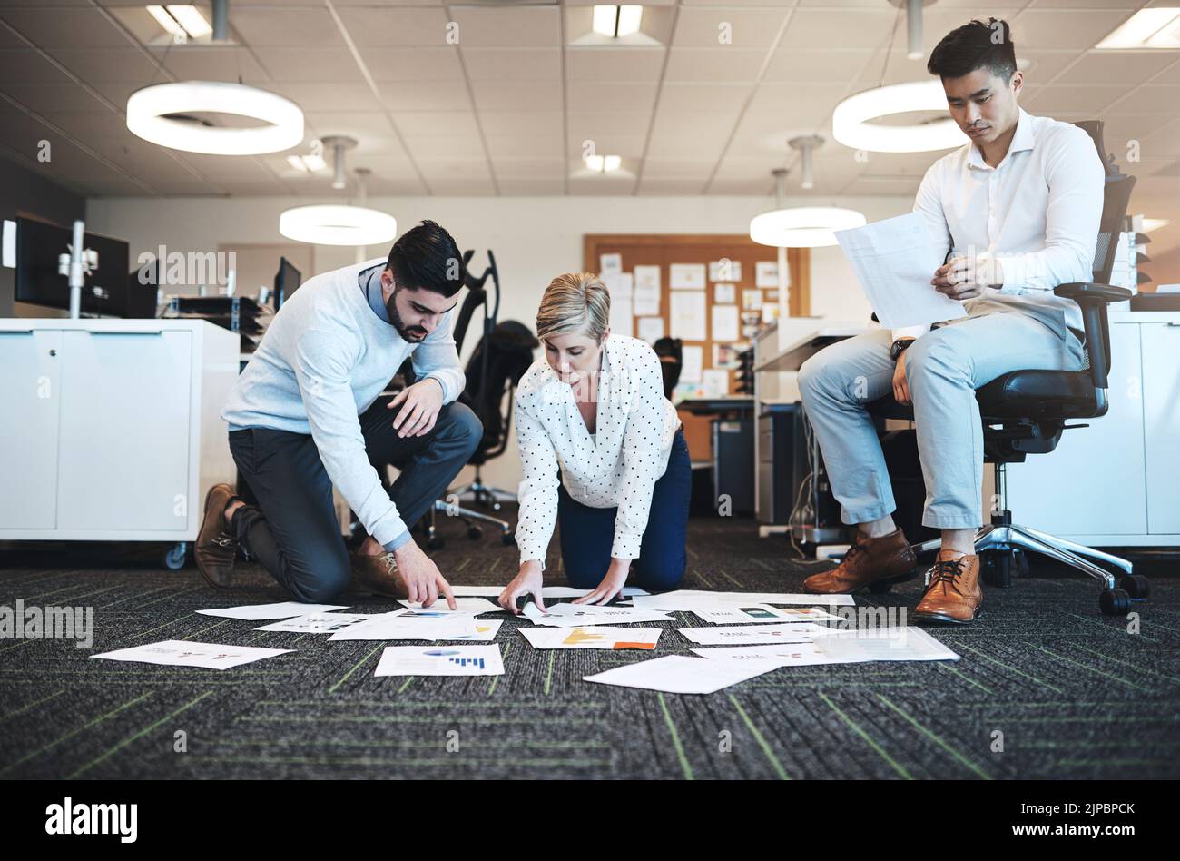 Putting their heads together. Full length shot of three young ...