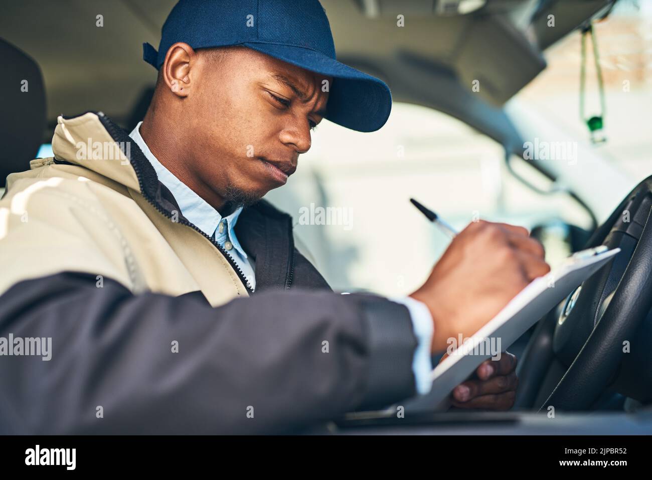 He makes no mistakes with his deliveries. a courier writing on a ...