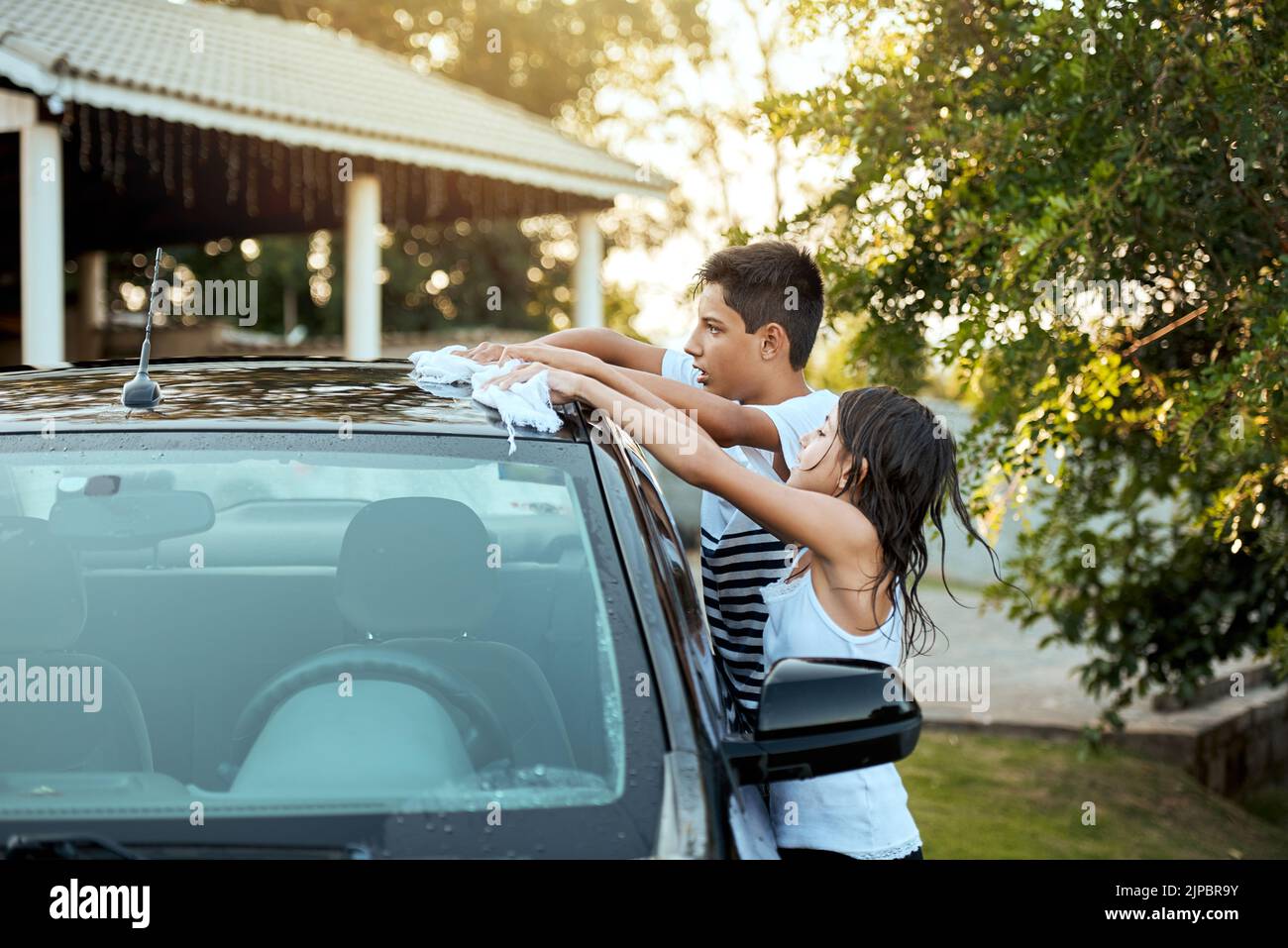 Working together to make the work go quicker. two cheerful children ...