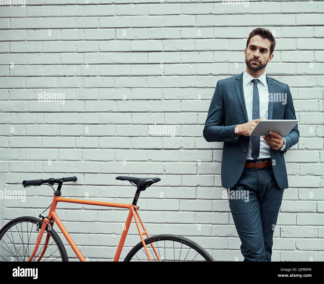 Everything he does is with convenience in mind. a handsome young businessman using a digital ...