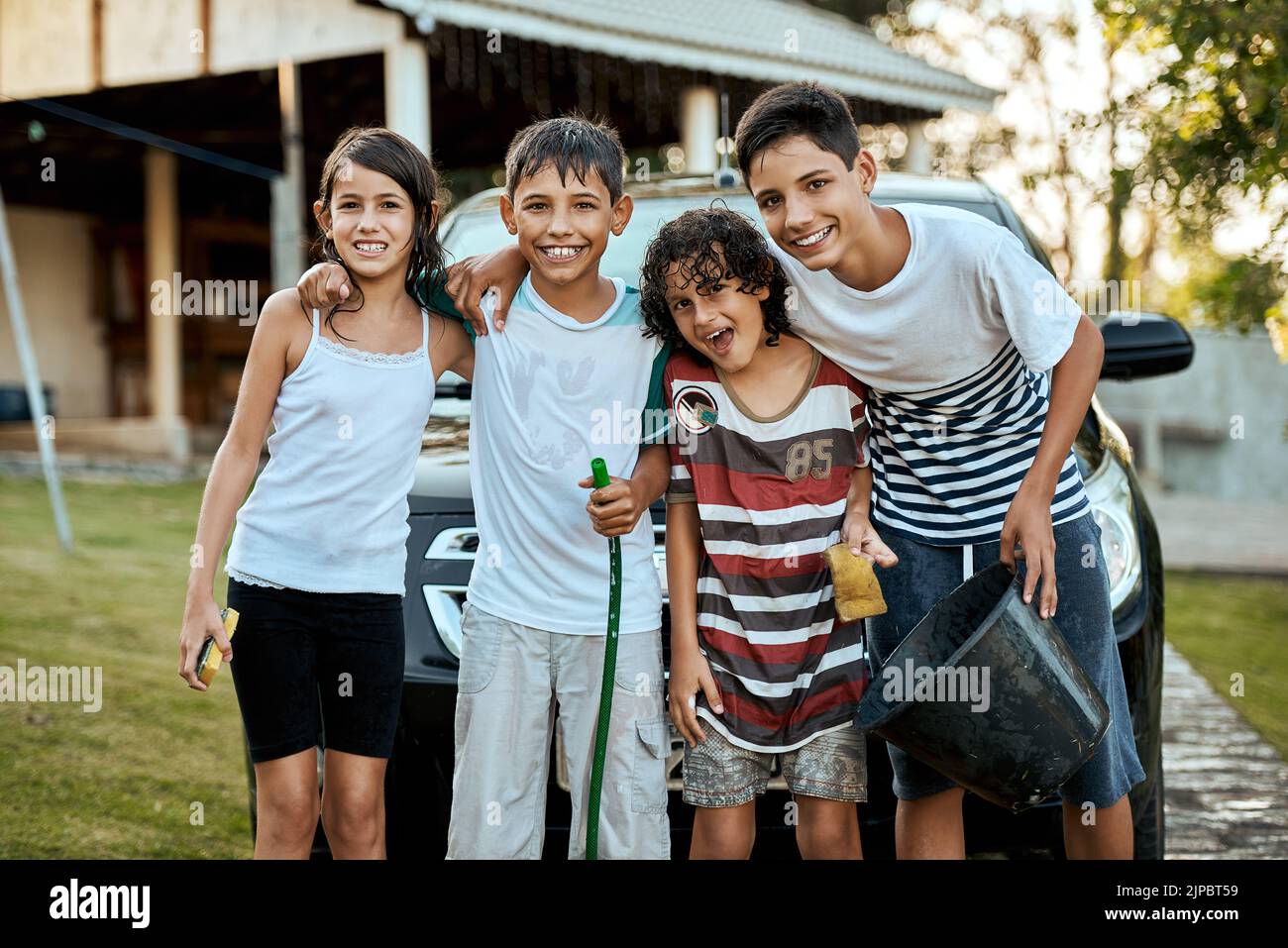More hands equals less work. Portrait of a group of young kids standing ...