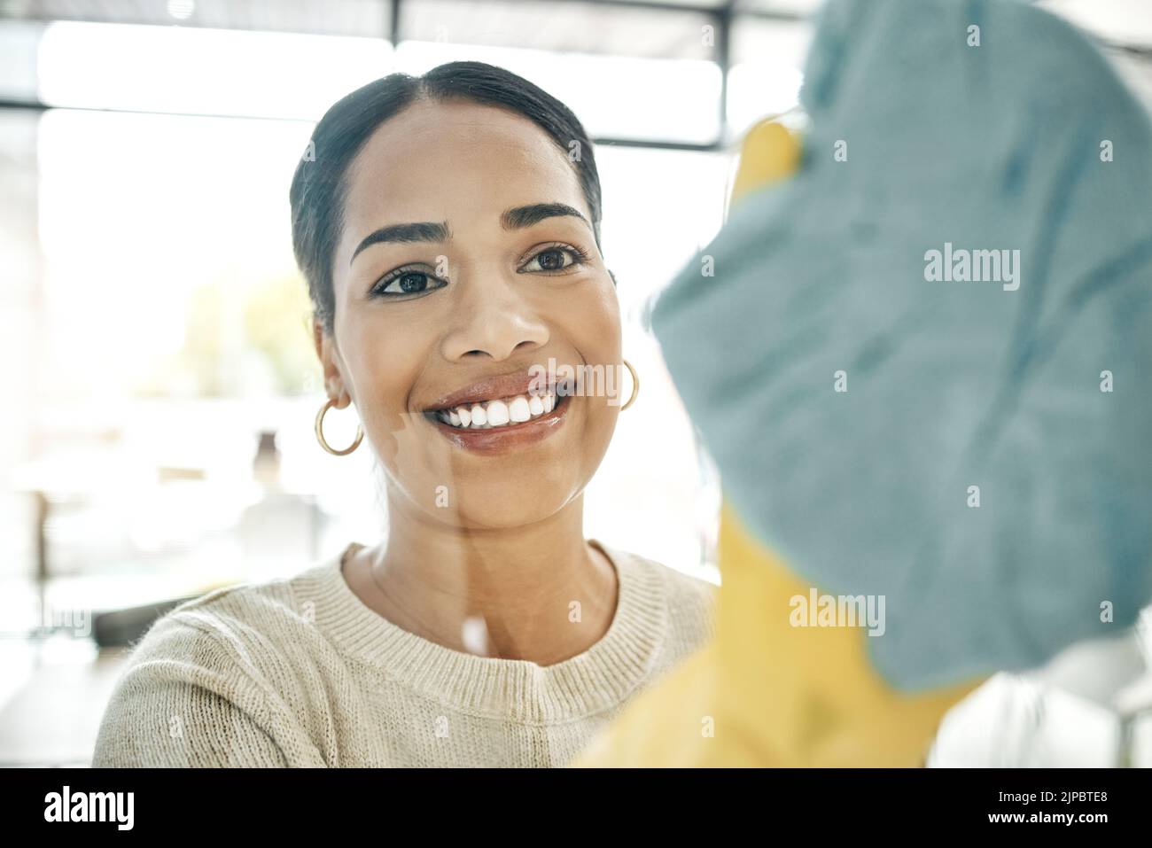 Cleaning, chores and cleaner wiping windows with a soft cloth while ...