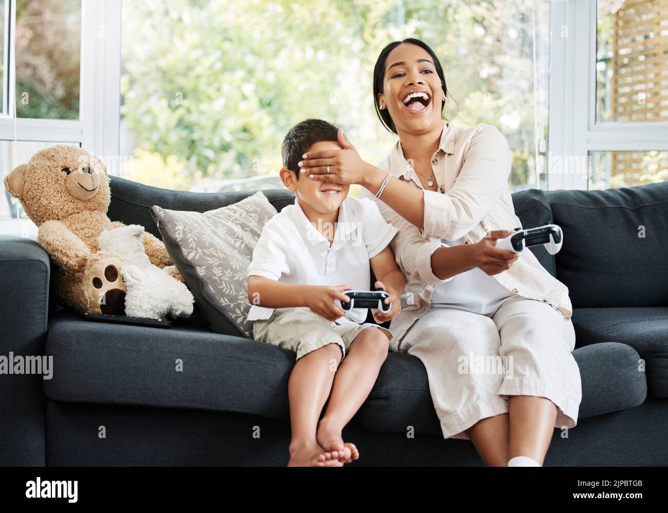 Mother and son playing video games, having fun and enjoying quality ...