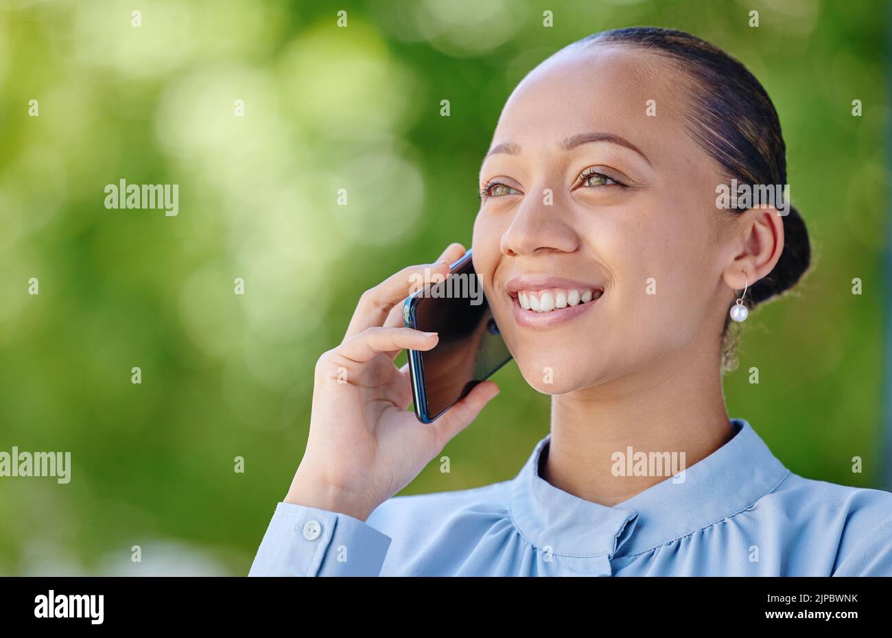 Woman calling, smiling and talking on a phone call while standing ...