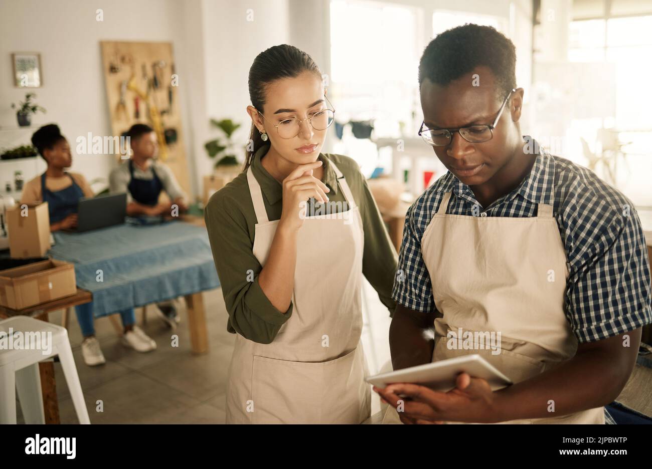 Young and creative carpenter students in workshop planning or ...