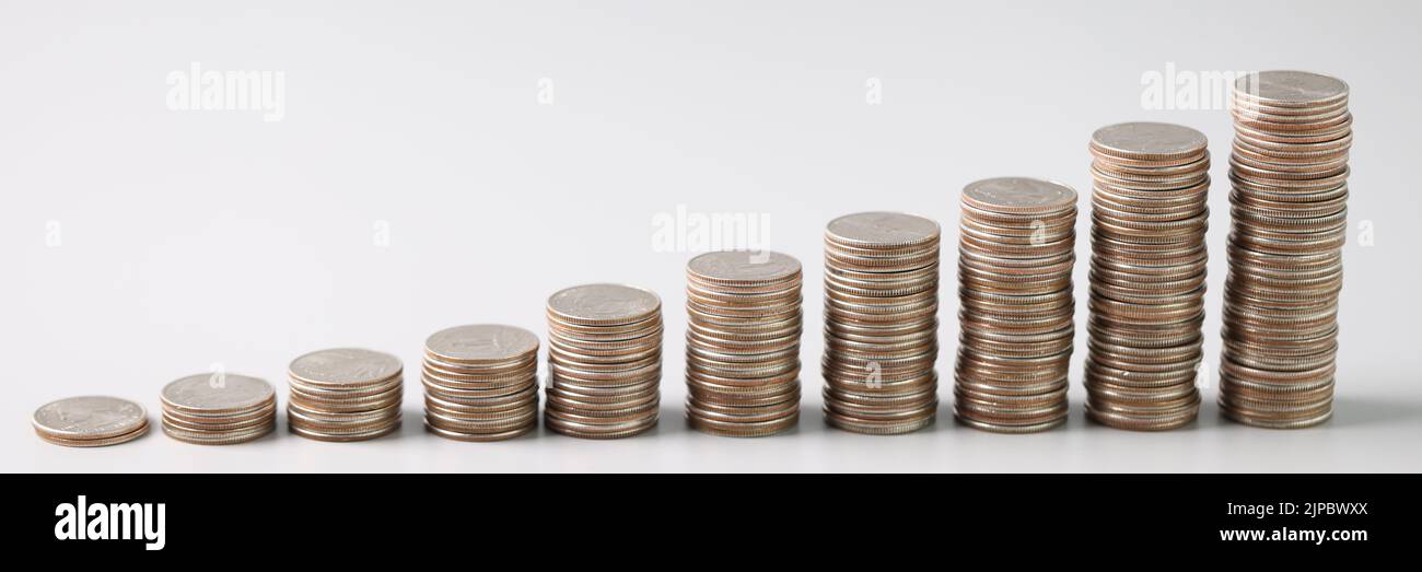 Stacks of silver coins in ascending order on light gray background ...