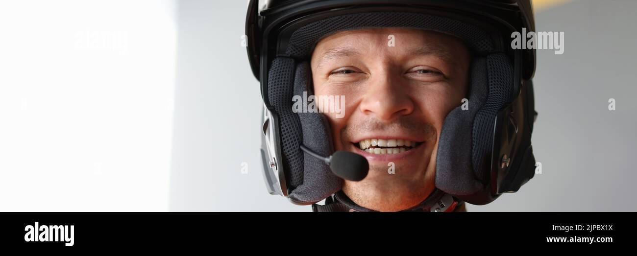Smiling man in motorcycle helmet with speakerphone Stock Photo - Alamy