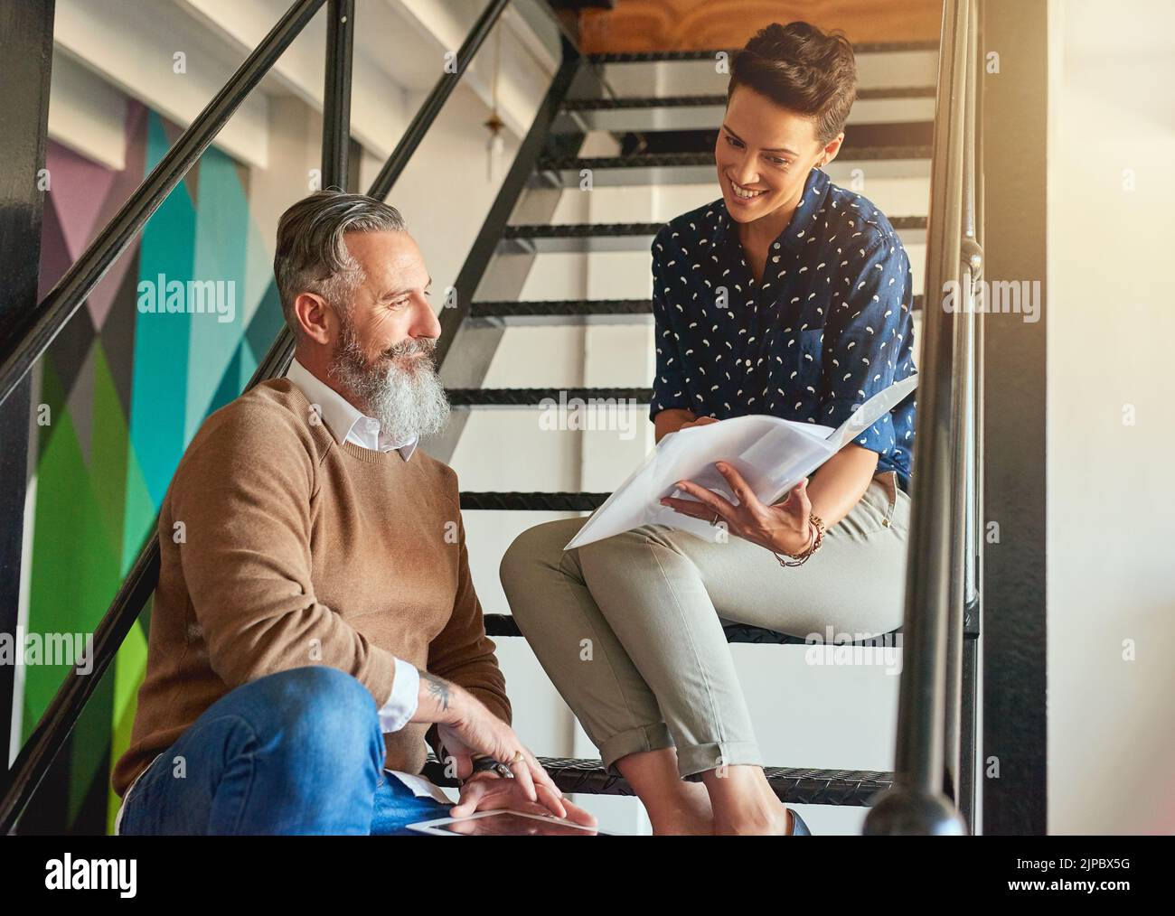 Discussing documents. creative colleagues discussing a document on ...