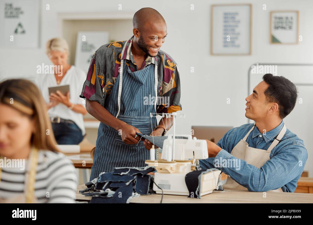 Fashion designers, colleagues and men sewing clothes in a workshop ...