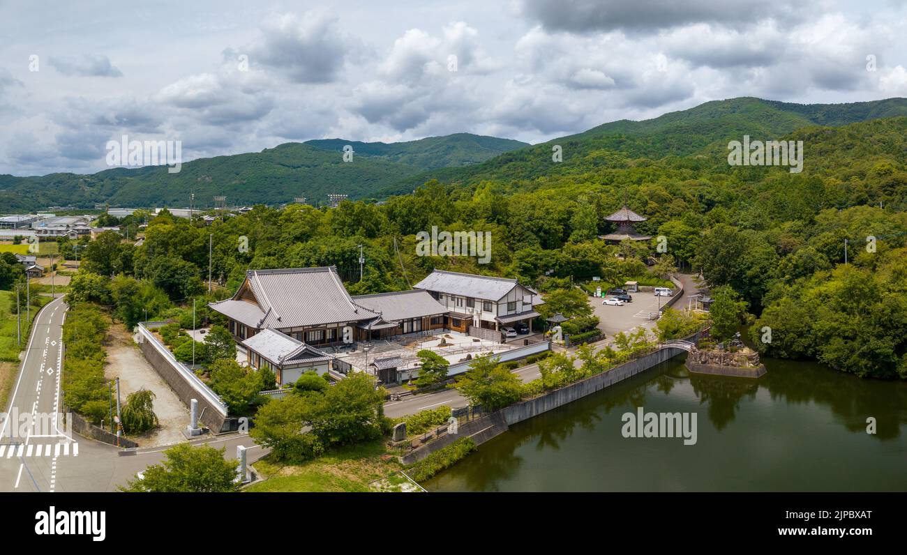 Aerial view of traditional Japanese building between forest and road on ...