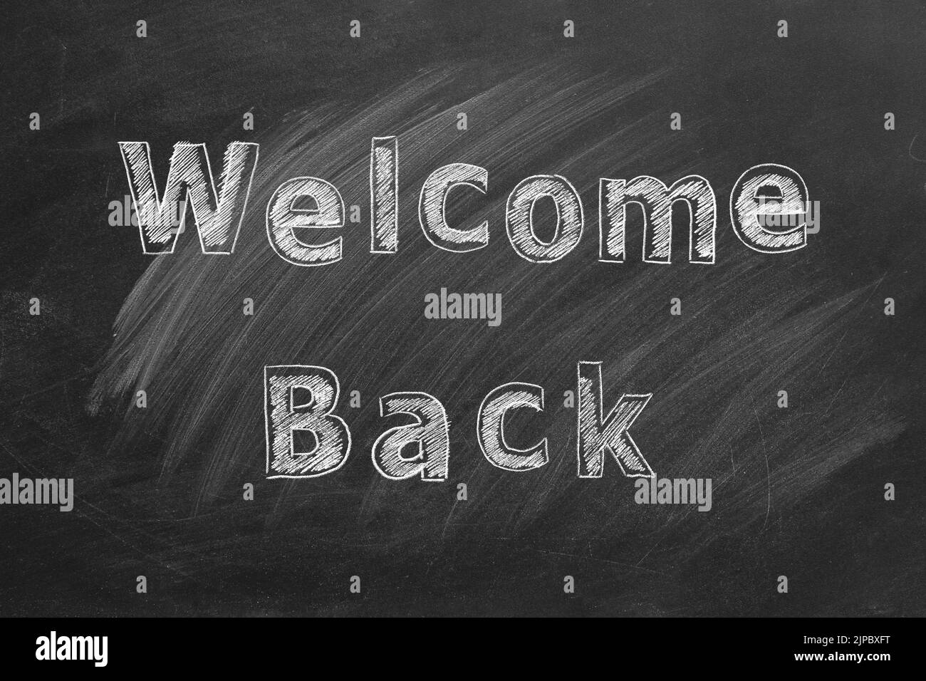 Hand drawn WELCOME BACK text on blackboard Stock Photo - Alamy